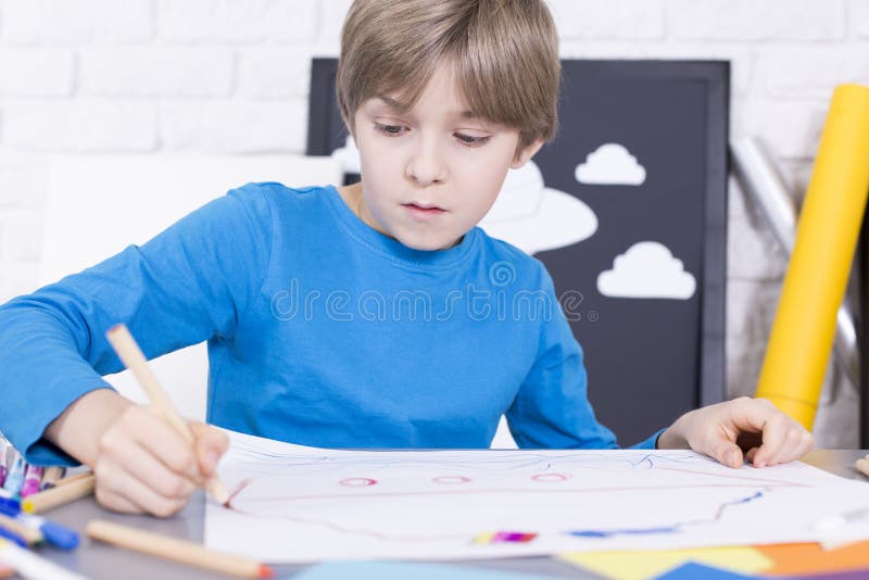 Boy Drawing Something on a Piece of Paper Stock Image - Image of ...