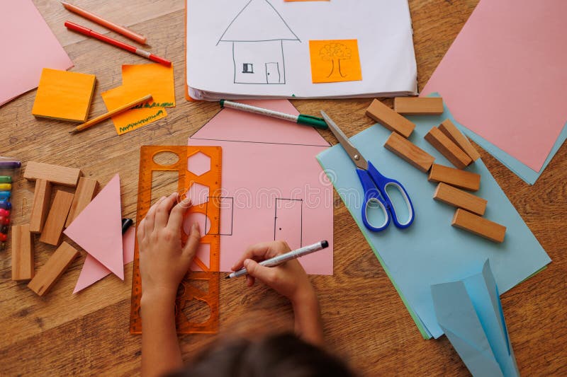 Boy Draws a House. the Child Makes a Layout of the House. the Boy is ...