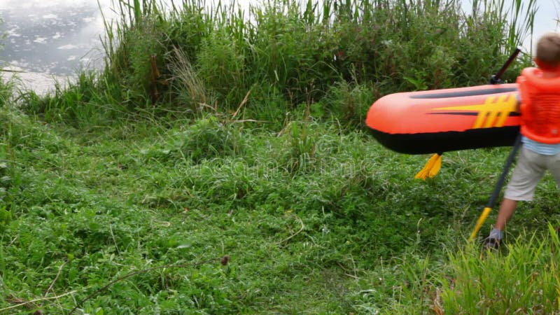 Boy Dressed in Life Jacket Moving Inflatable Stock Footage - Video of ...