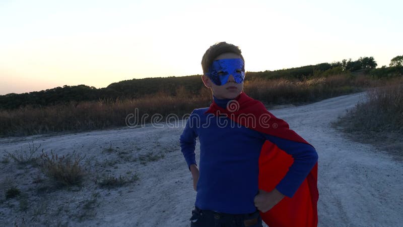 A Boy Dressed Up with a Cape of Superman Standing on a Mountain Looking ...