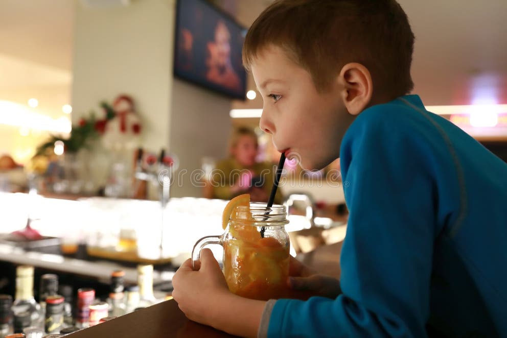 Boy Drinking Lemonade with Ice at Bar Stock Photo - Image of night, fresh: 239316964