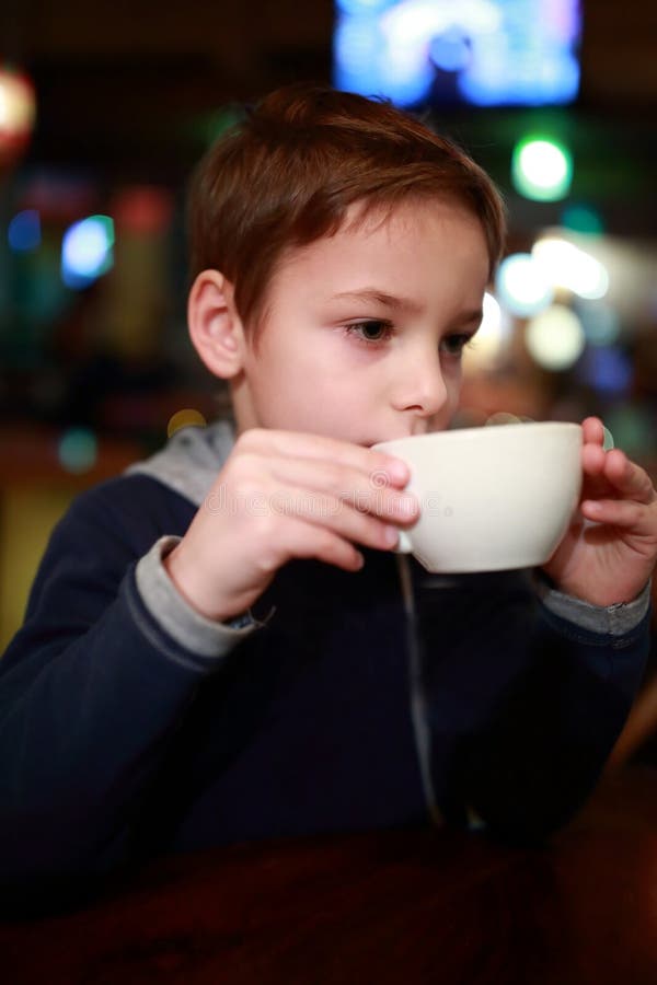 Boy drinking tea stock image. Image of childhood, food - 105631247