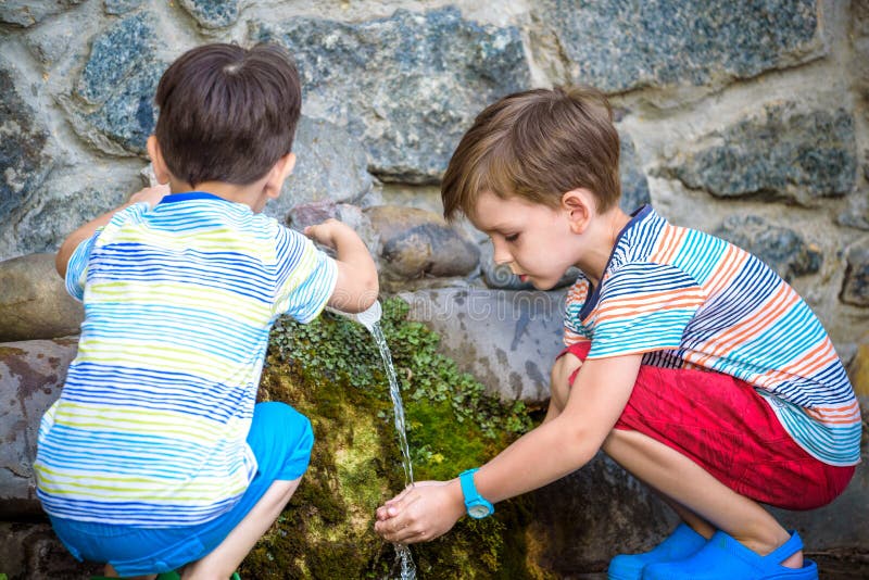 The Boy Drinks Cold Water Outdoors from the Pipe Stock Photo - Image of ...