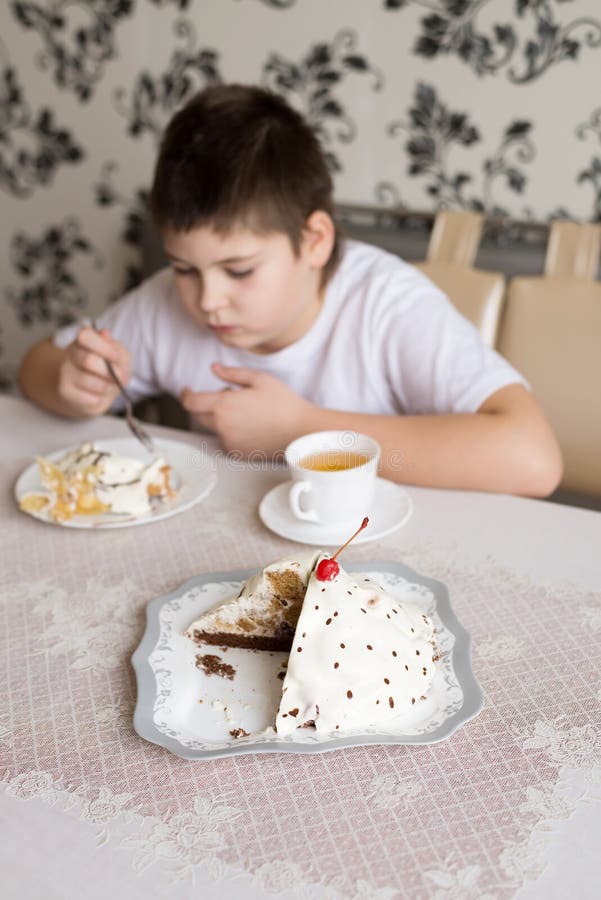 Boy Drinks Tea with Cake at Table Stock Image - Image of drink ...
