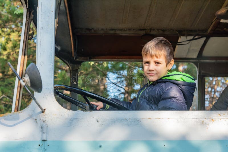 A Boy Drive a Bus. the Boy Turns the Steering Wheel in the Abandoned ...