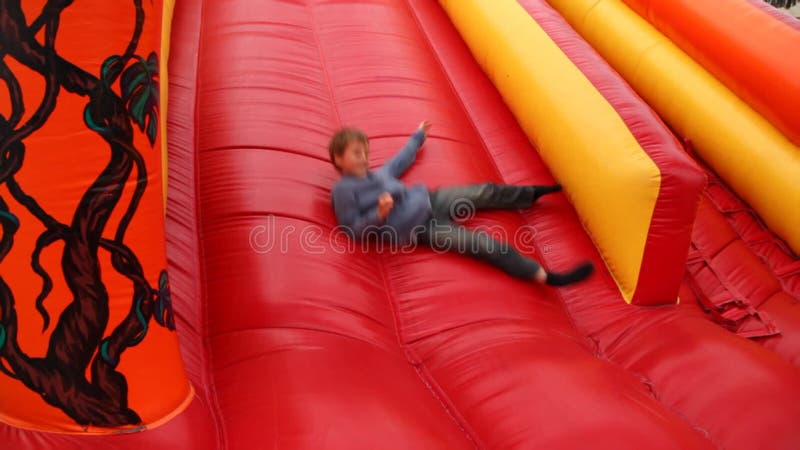 Boy Drives Off with Big Red Inflatable Rubber Stock Footage - Video of ...