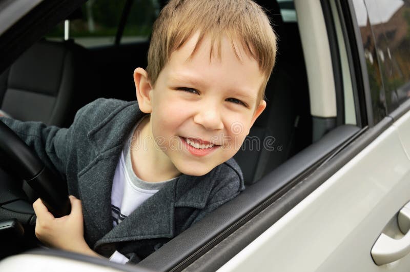 Boy driving a car stock image. Image of delighted, automobile - 34497385