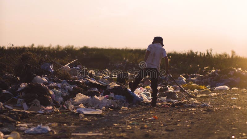 Boy in dump stock image. Image of dust, backlit, kicking - 153416263