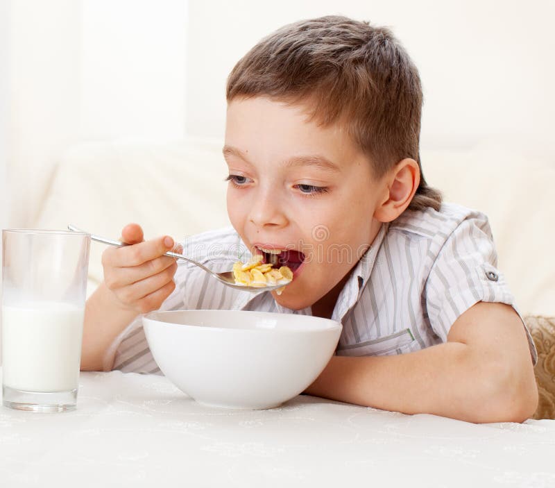 Boy eat breakfast at home stock photo. Image of person - 65208442