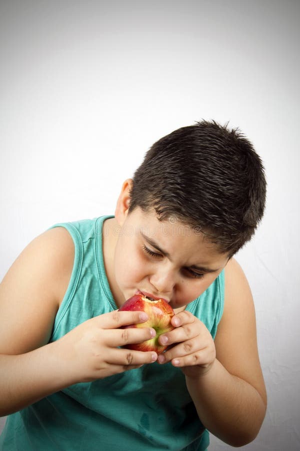 The Boy is Eating Apple stock image. Image of uncomfortable - 44841943