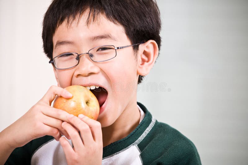 A boy eating an apple stock photo. Image of male, school - 9409828
