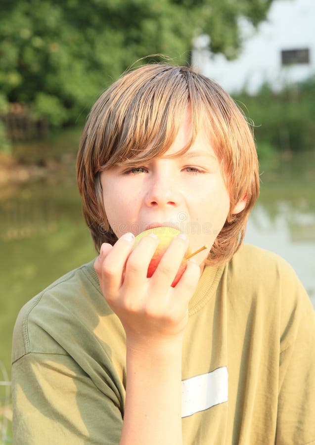 Boy eating an apple stock image. Image of apple, biting - 44201153