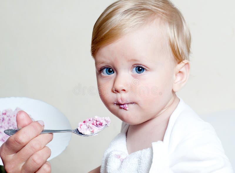 Boy Eating Baby Food with Spoon Stock Photo - Image of face, emotion ...