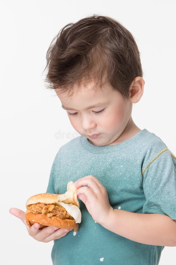 Boy eating a burger stock image. Image of delicious, meat - 32810945