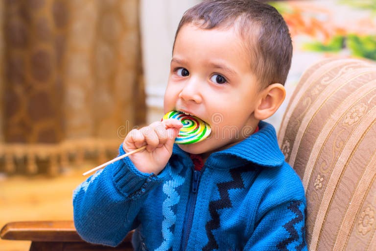 Boy eating candy stock photo. Image of tasty, multicolored - 65413496