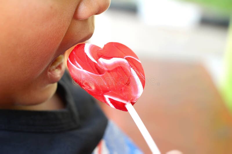 A Boy Eating Candy Valentines Hearts Stock Image - Image of heart ...