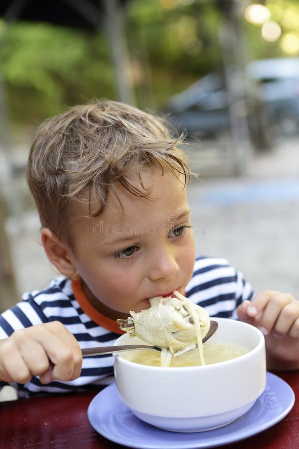 Boy eating chicken soup stock photo. Image of healthy - 78695908