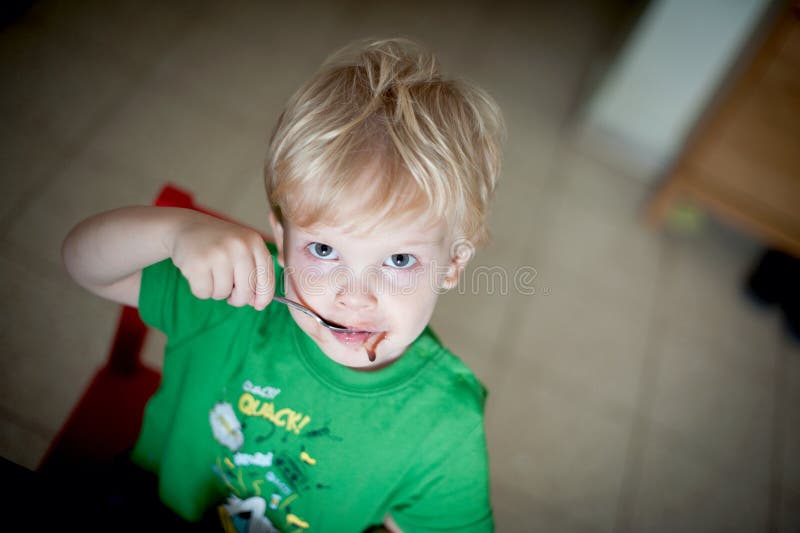 Boy Eating Chocolate Pudding Stock Photo - Image of home, smile: 22112362