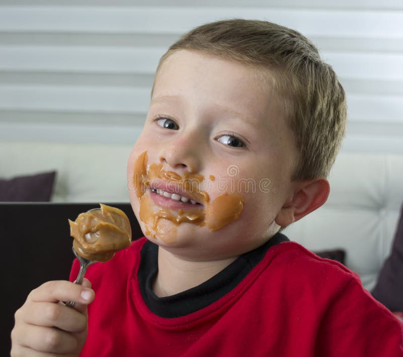Boy eating chocolate. stock image. Image of indulge, cook - 84142939