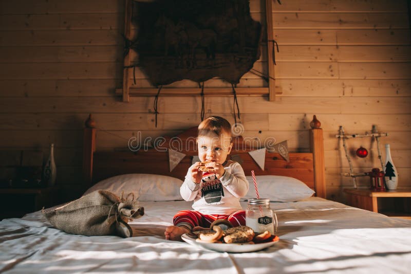 Boy eating cookies in bed stock image. Image of child - 82622117