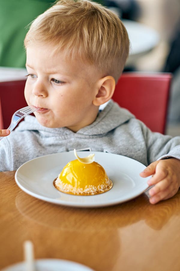 Boy eating dessert in cafe stock photo. Image of child - 156572084