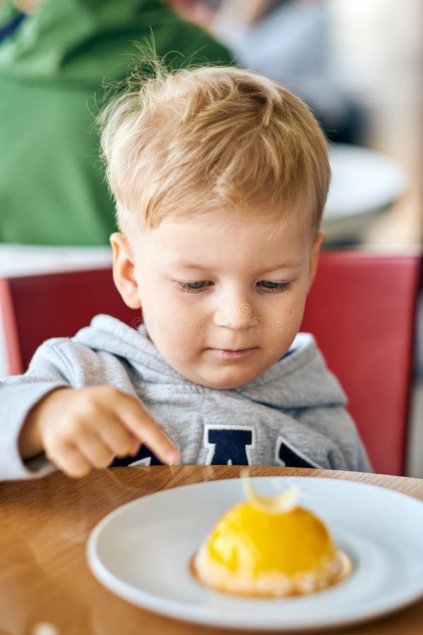 Boy eating dessert in cafe stock image. Image of cheerful - 158216613