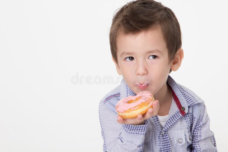 Boy eating a donut stock image. Image of humor, childhood - 32810761