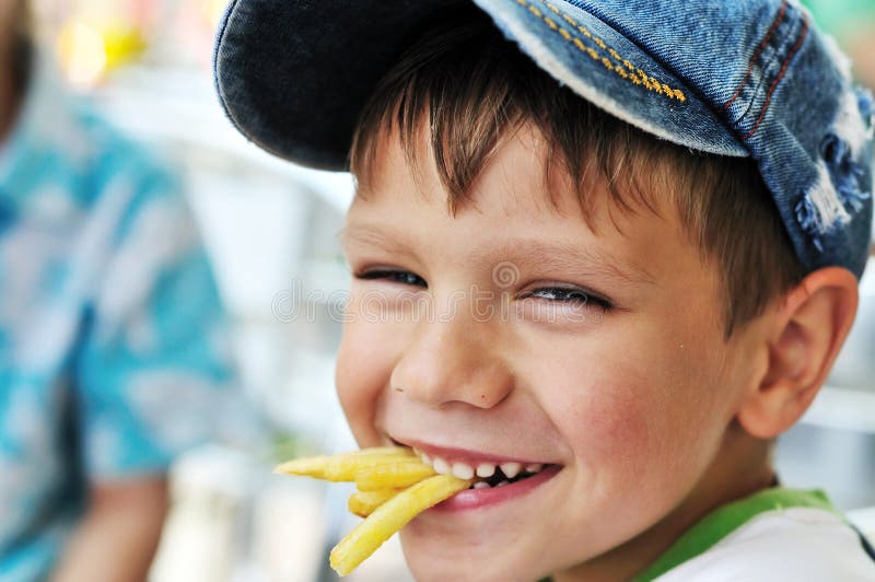 Boy eating french fries stock photo. Image of male, diet - 14632926