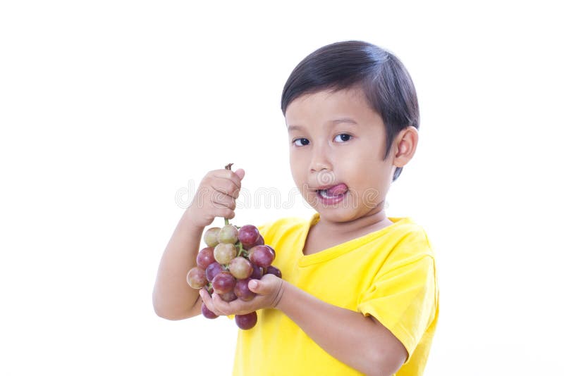 Boy eating grapes stock photo. Image of grape, purple - 44634178