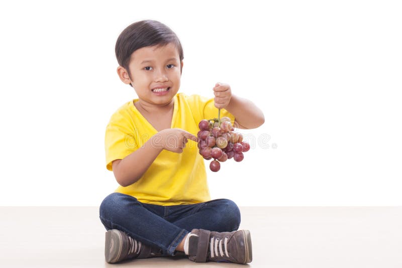 Boy eating grapes stock photo. Image of fingers, food - 44634352