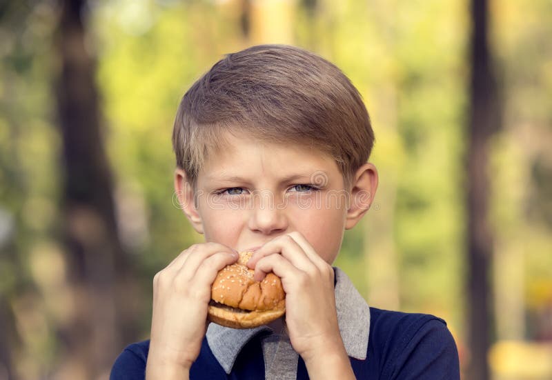 Boy eating a hamburger stock image. Image of person, breakfast - 44702205