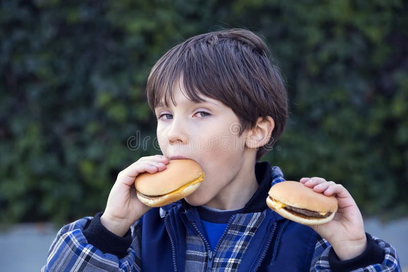 Boy eating a hamburger stock image. Image of european - 46879373