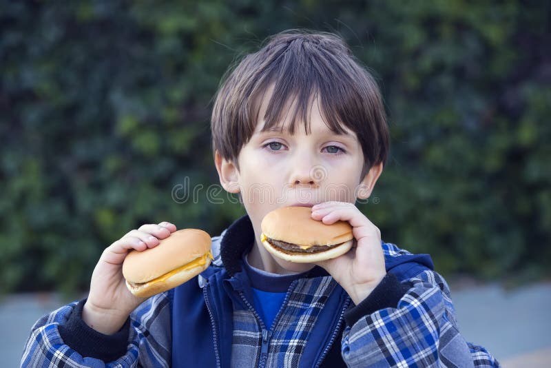 Boy eating a hamburger stock image. Image of happy, growth - 46879409