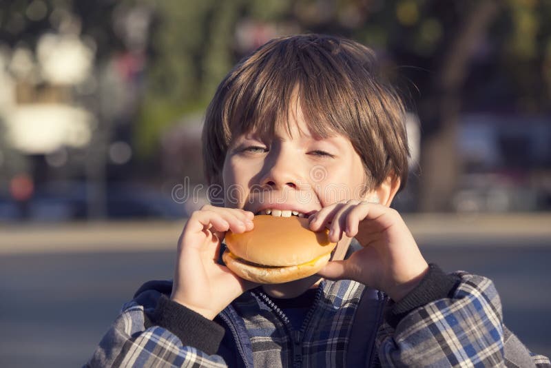 Boy eating a hamburger stock image. Image of lifestyle - 46879529