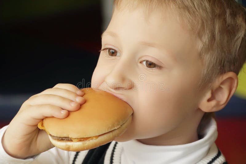 Boy eating hamburger stock image. Image of cute, white - 38786825