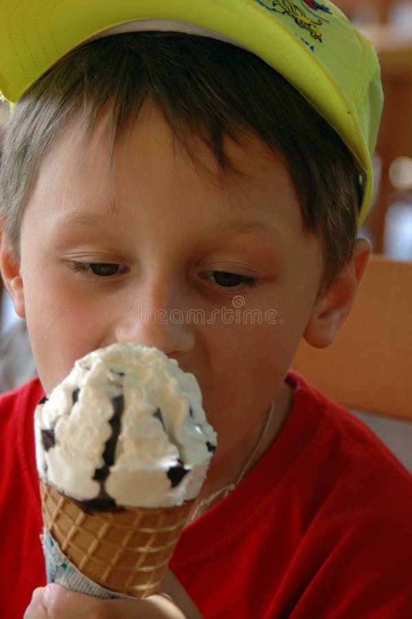 Boy eating ice cream cone stock image. Image of fattening - 5956159
