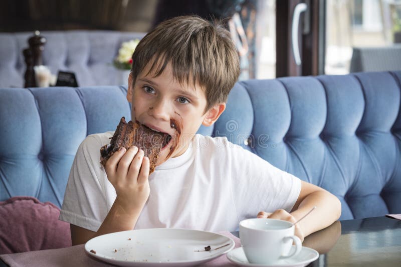 The Boy is Eating a Large Piece of Cake Stock Image - Image of mains ...