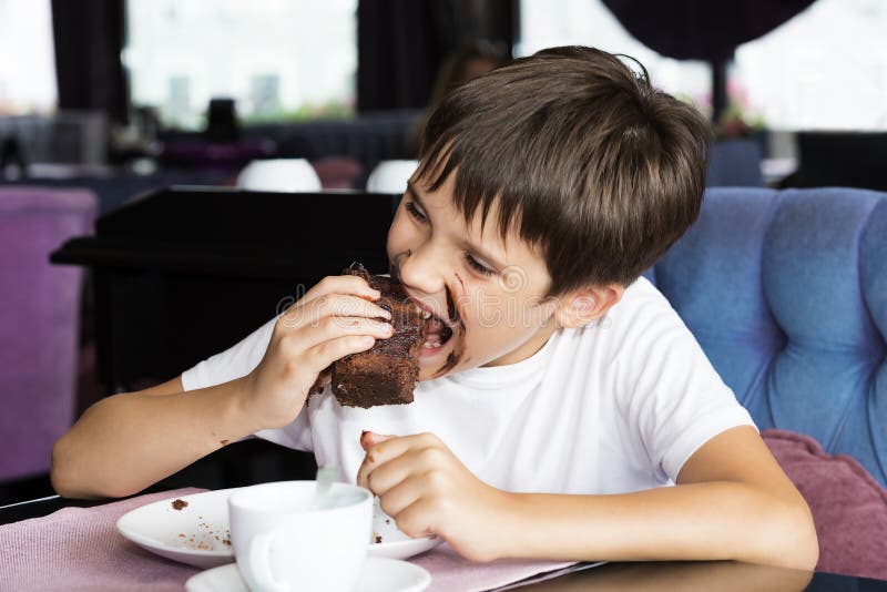 The Boy is Eating a Large Piece of Cake Stock Image - Image of buns ...