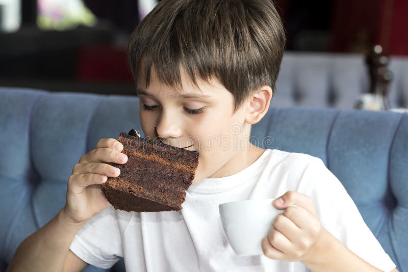 The Boy is Eating a Large Piece of Cake Stock Image - Image of mains ...