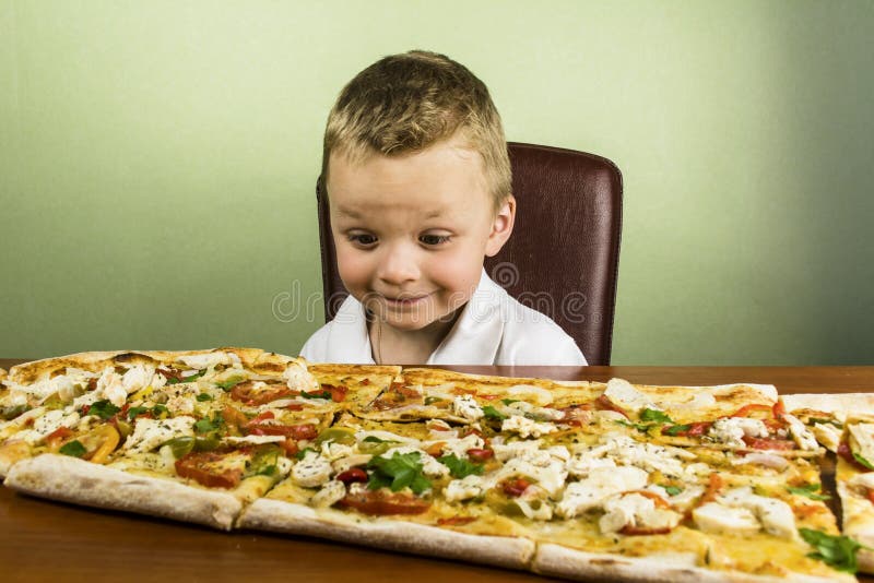 Boy eating a large pizza stock image. Image of pizza - 74686843