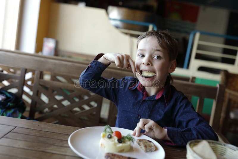 Kid eating mashed potatoes stock photo. Image of appetite - 113489674