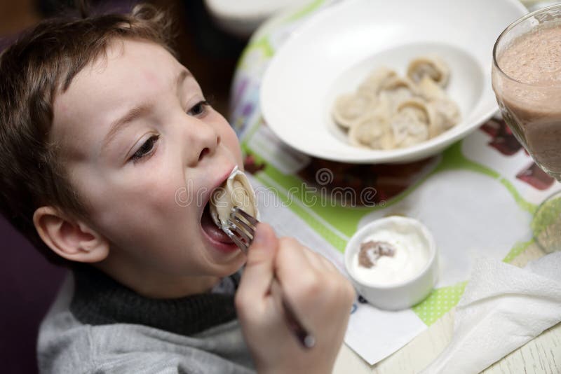 Boy eating meat dumplings stock image. Image of hungry - 69162325