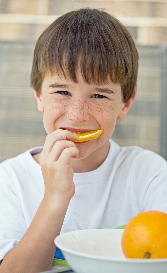 Boy Eating Orange Slice stock image. Image of child, children - 6201691