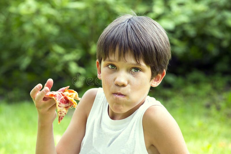 The boy is eating pizza stock image. Image of piece, child - 99950365
