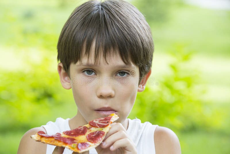 Boy eating pizza stock image. Image of childhood, appetite - 82338159