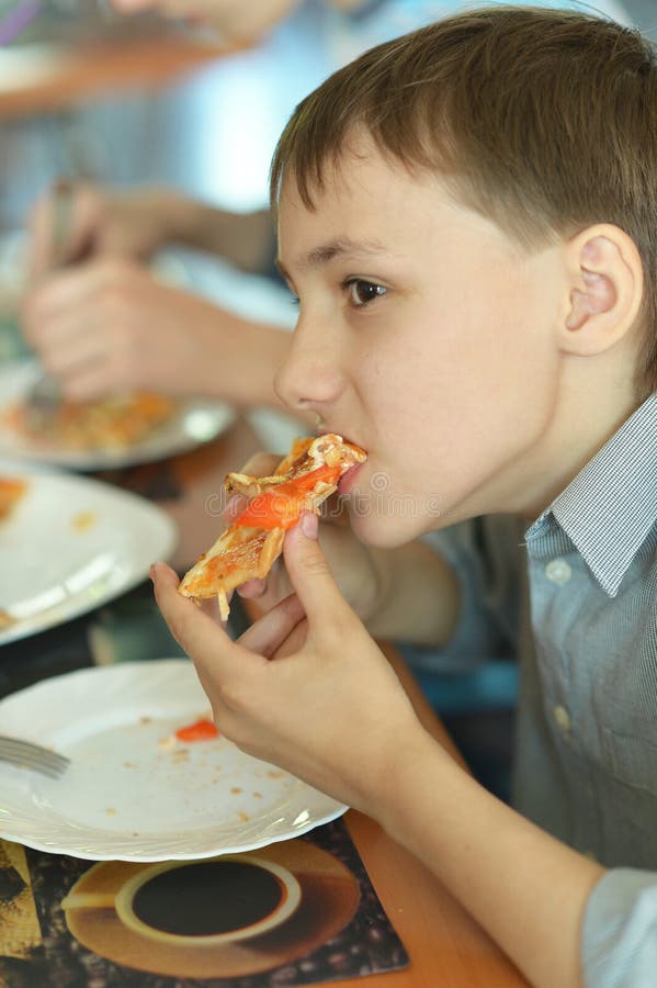 Boy eating pizza stock photo. Image of comfort, male - 47951466