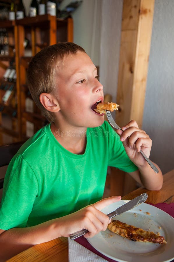 Boy eating pizza stock photo. Image of preadolescent - 34748340