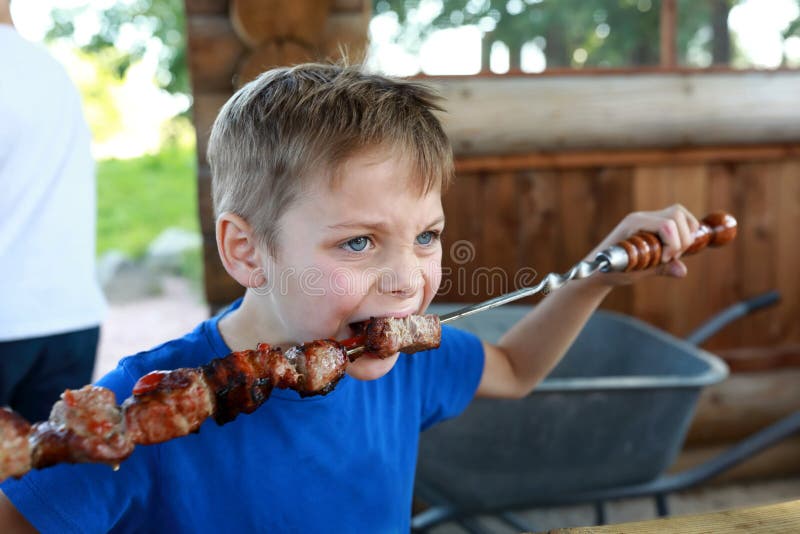 Boy Eating Pork Meat on Skewer Stock Image - Image of person, gourmet ...