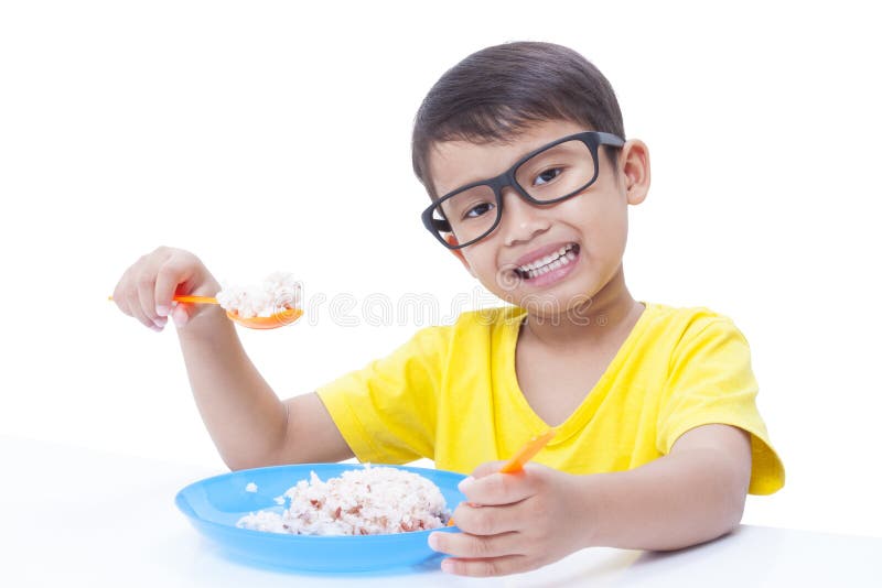 Boy eating rice. stock photo. Image of asia, food, bored - 47760688