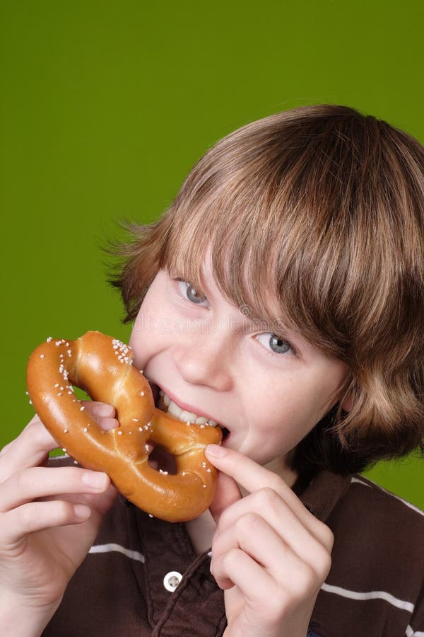 Boy eating a soft pretzel stock photo. Image of male, nutrition - 9696320